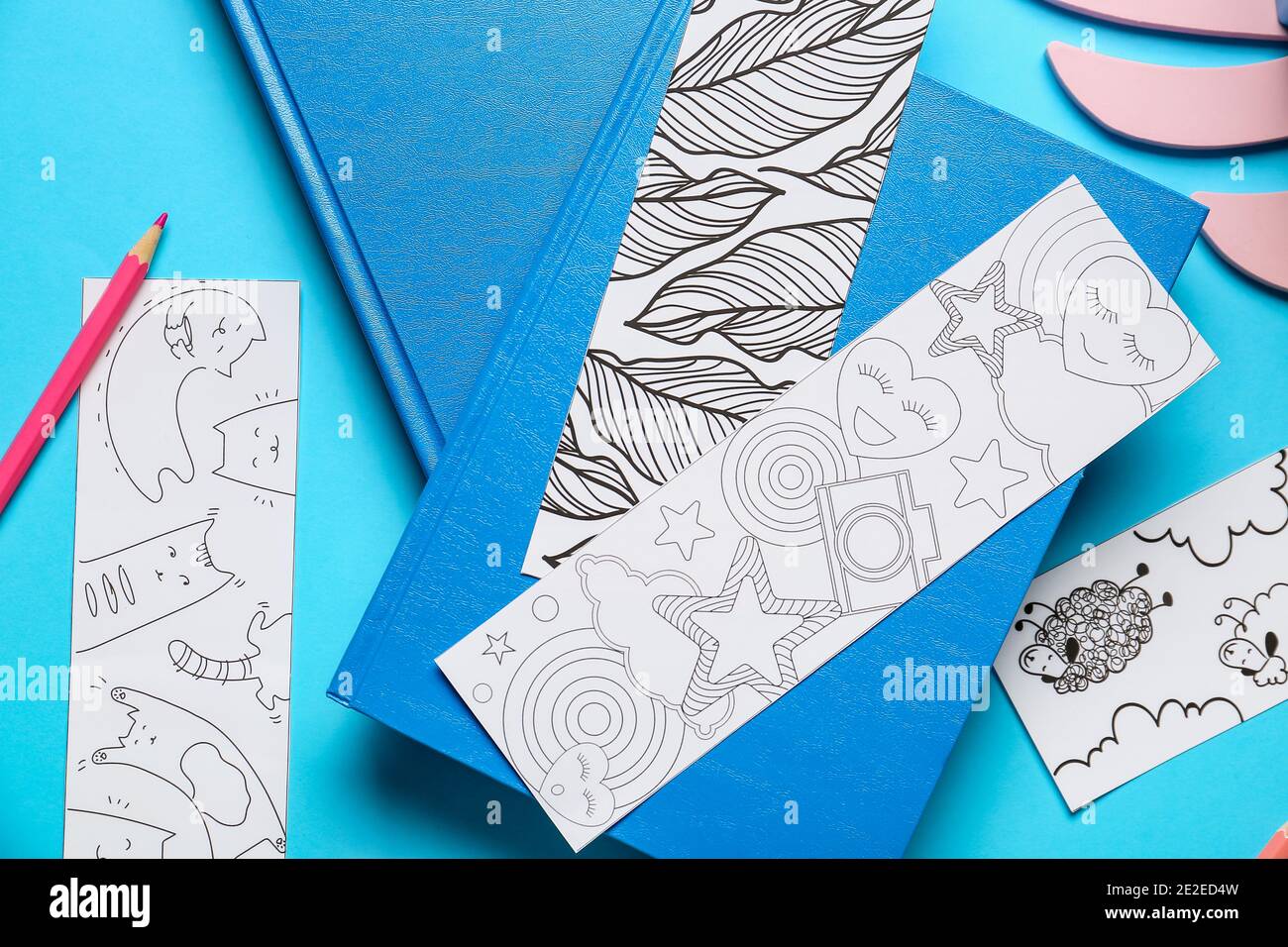 Cute bookmarks with books on color background Stock Photo - Alamy