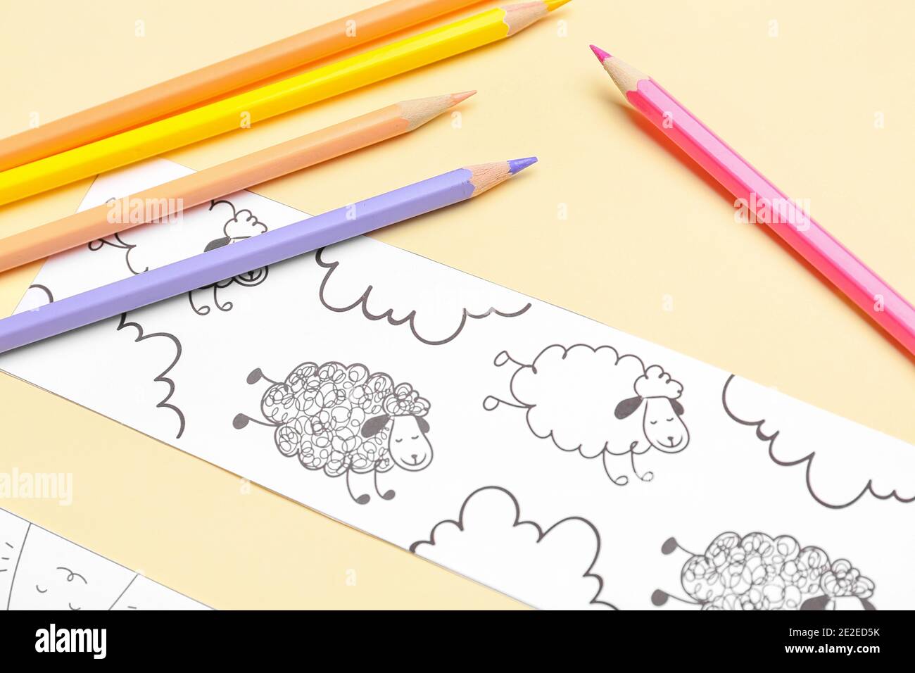 Cute bookmark with pencils on color background Stock Photo - Alamy