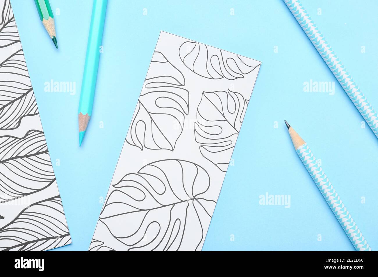 Cute bookmarks with pencils on color background Stock Photo - Alamy