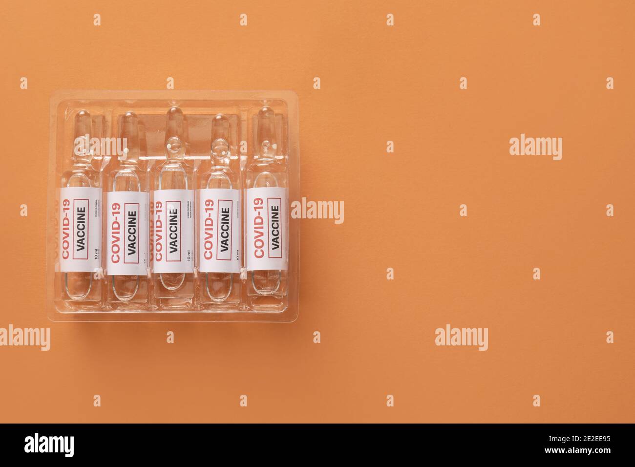 Vaccine for immunization against COVID-19 on color background Stock ...