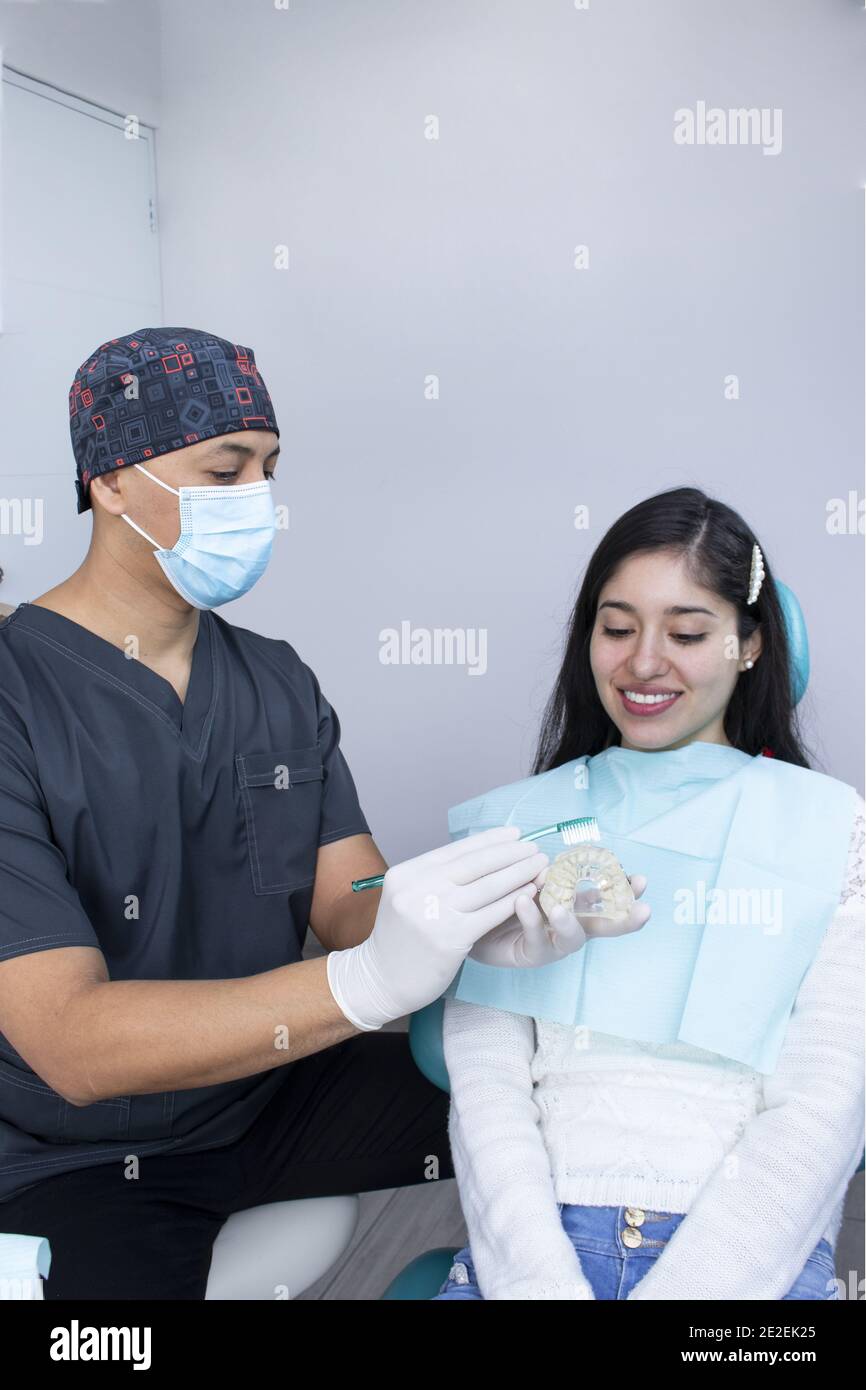 Vertical shot of the orthodontist showing how to correctly brush the ...