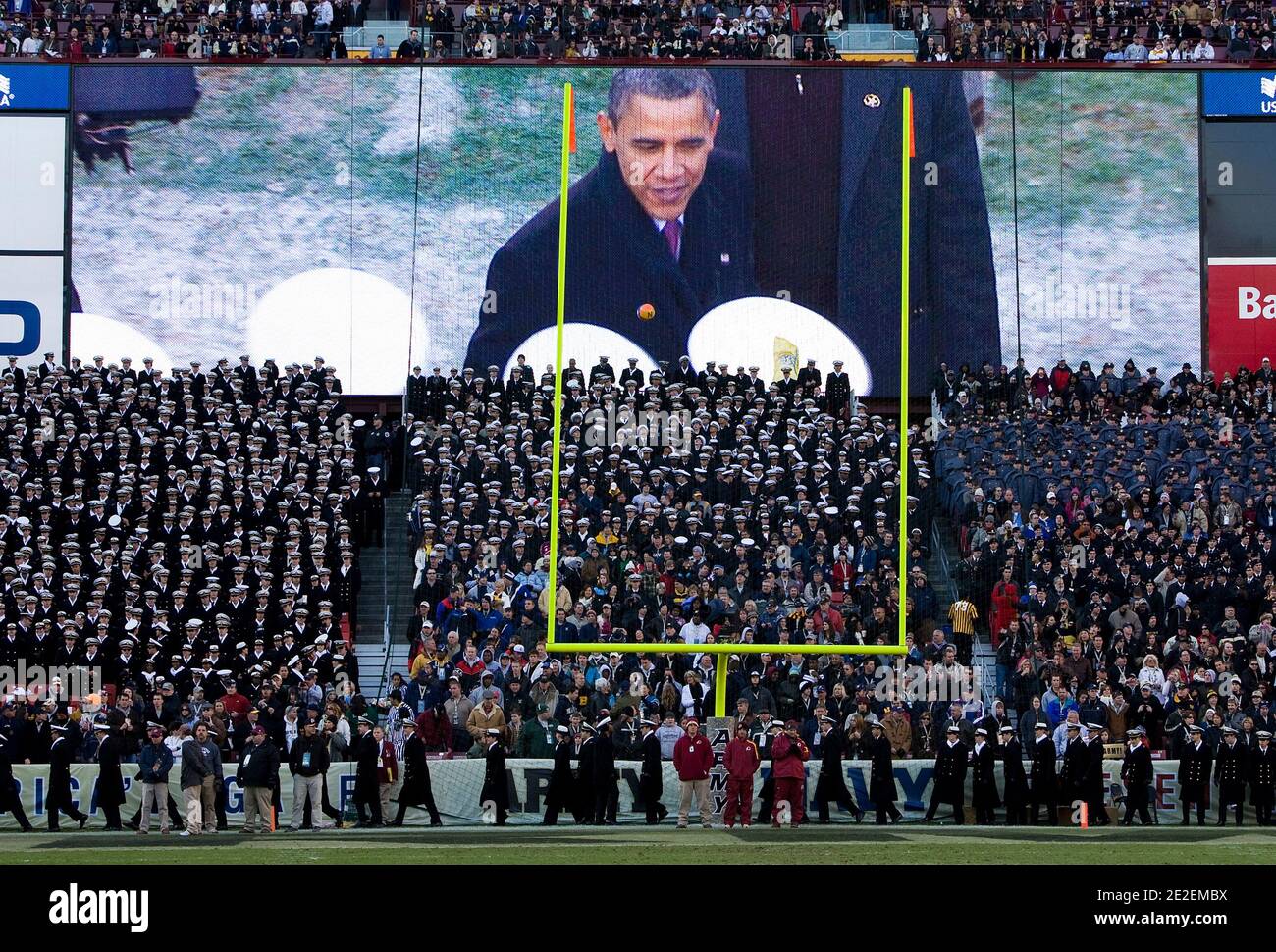 President Barack Obama, as see on a large video screen greets navy ...