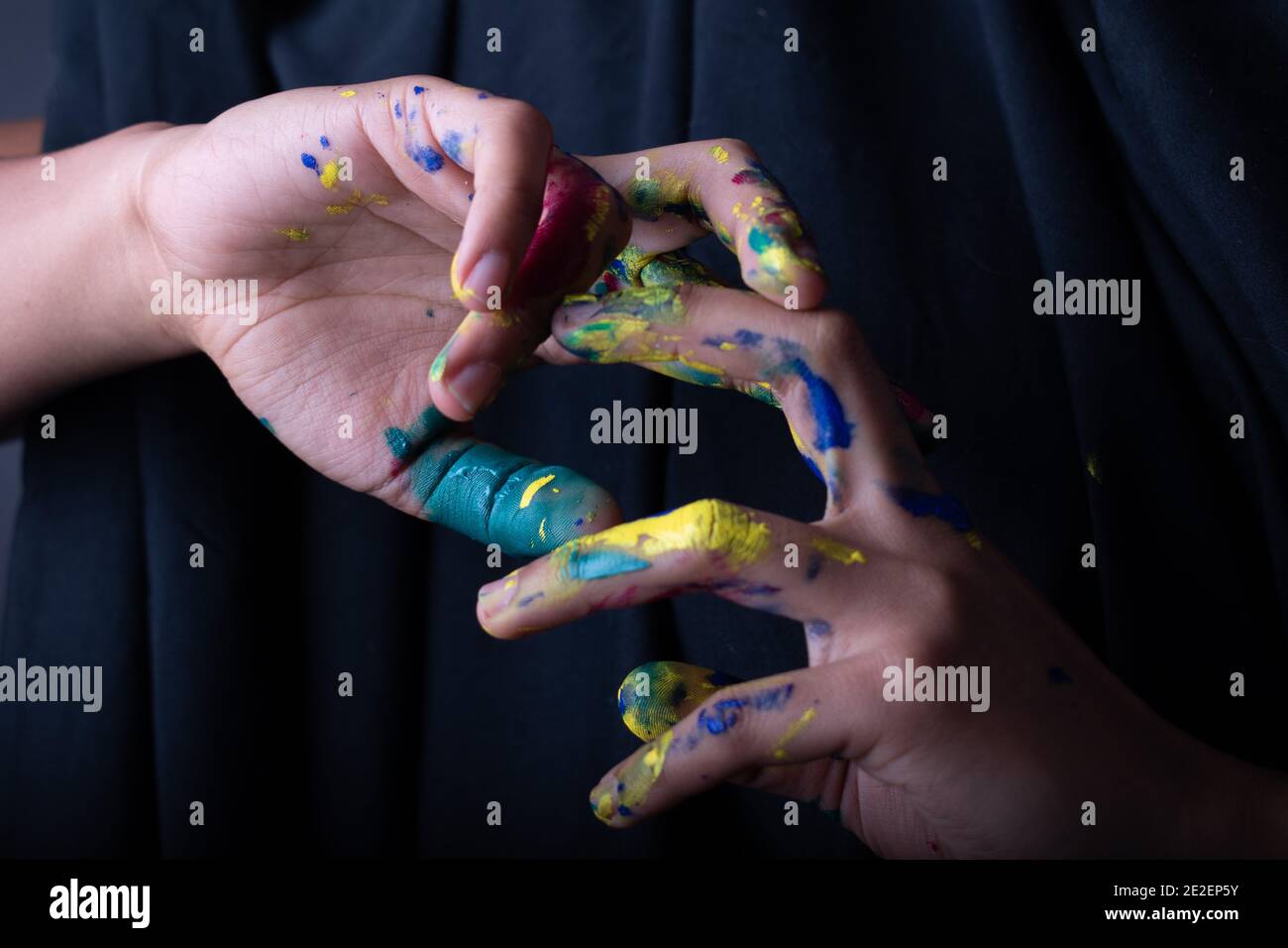 Artistic hand portrait with black background and colorful paint Stock ...