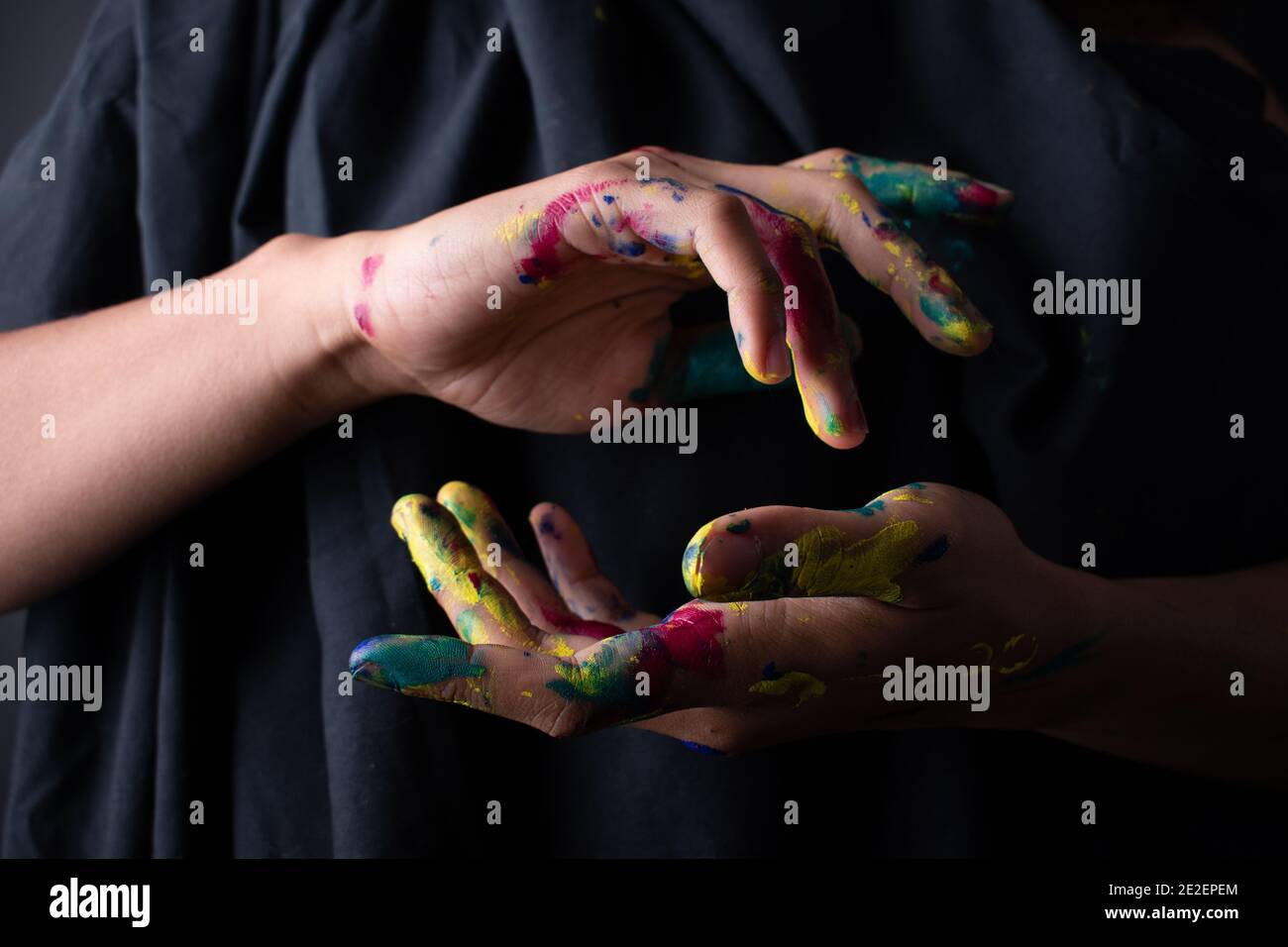Artistic hand portrait with black background and colorful paint Stock ...