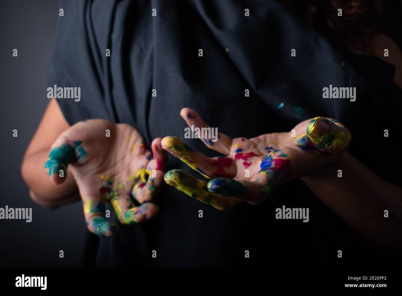 Artistic hand portrait with black background and colorful paint Stock ...