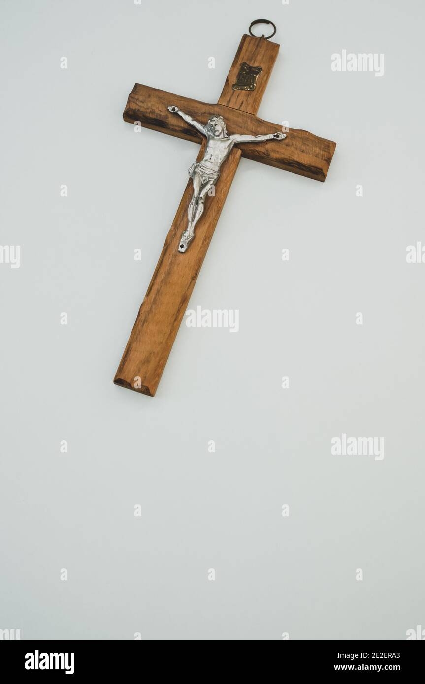 Vertical shot of a wooden crucifixion of Christ cross on a gray ...