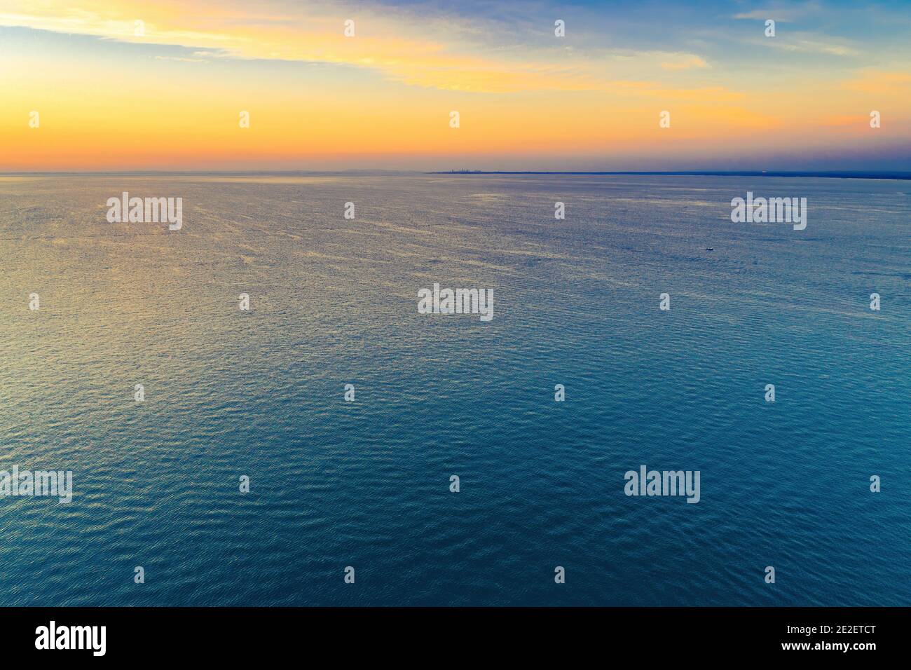 Aerial view of dawn over ocean with distant coastline Stock Photo - Alamy