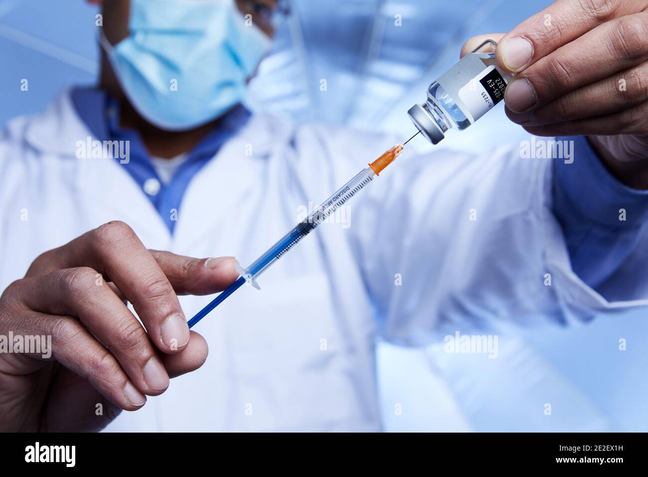 Close up of African American scientist interacting with syringe and ...