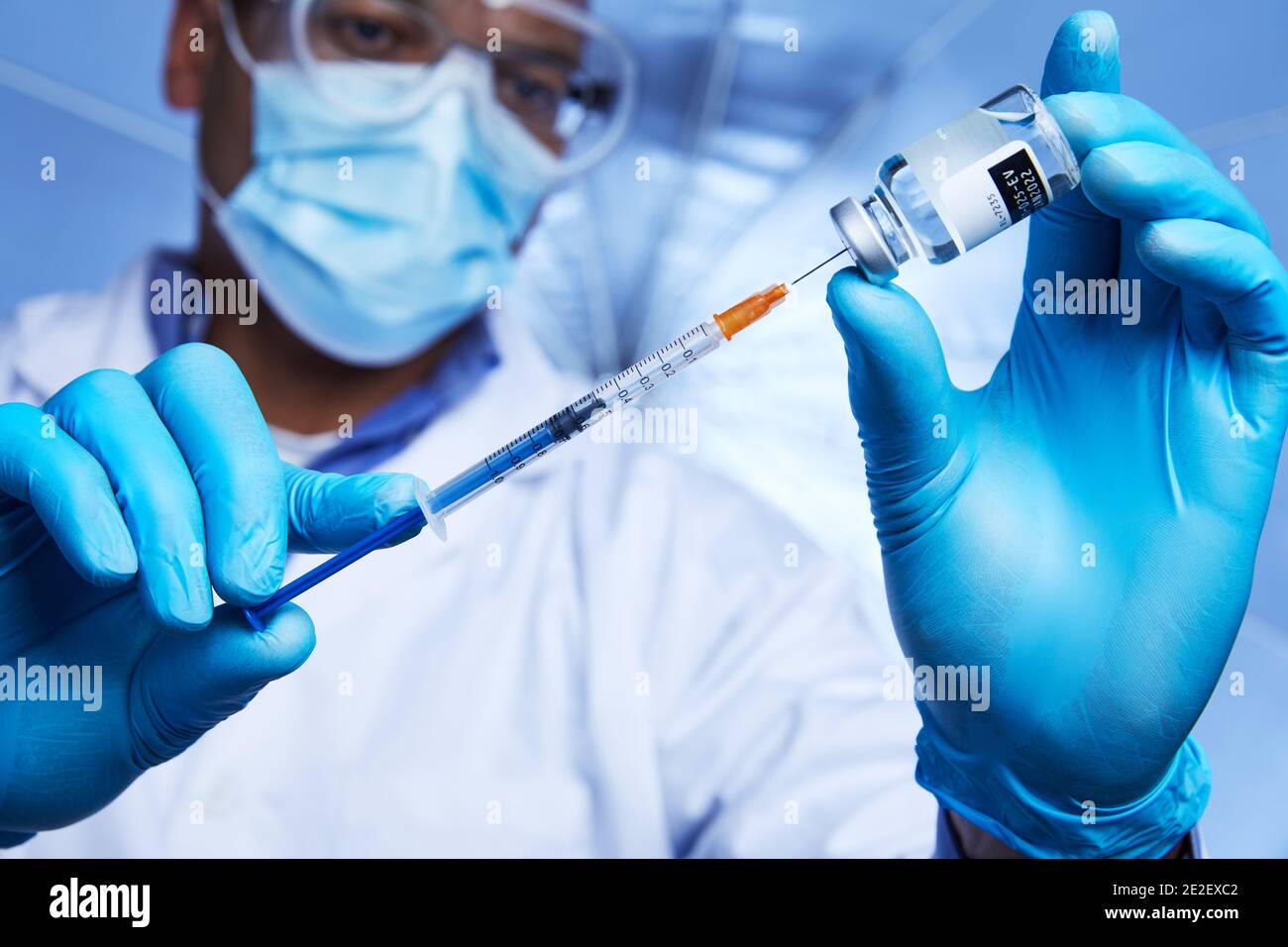 Close up of African American scientist interacting with syringe and ...