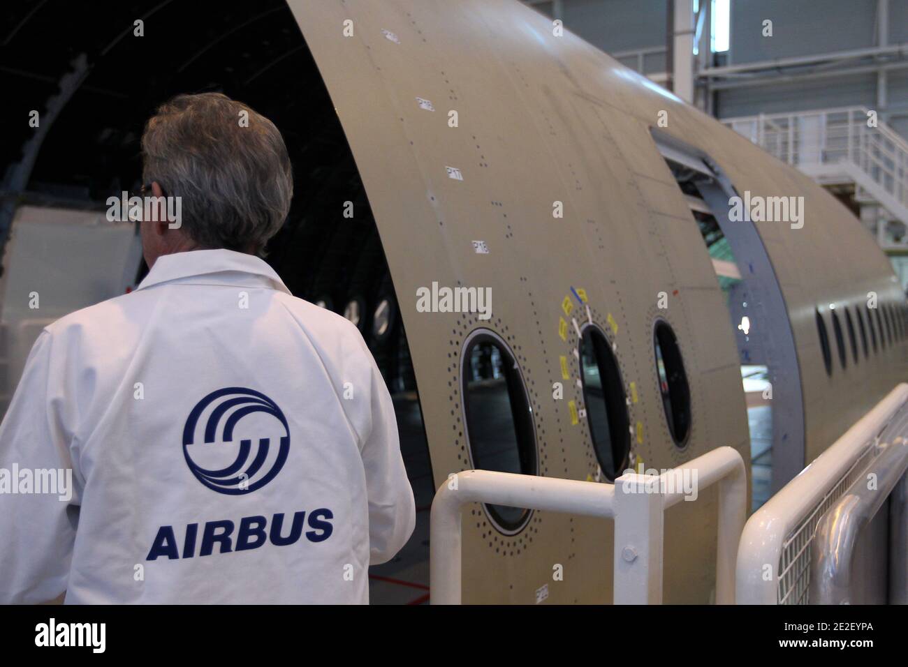 Airbus employees work in the cockpit section of an A350 Airbus airplane ...