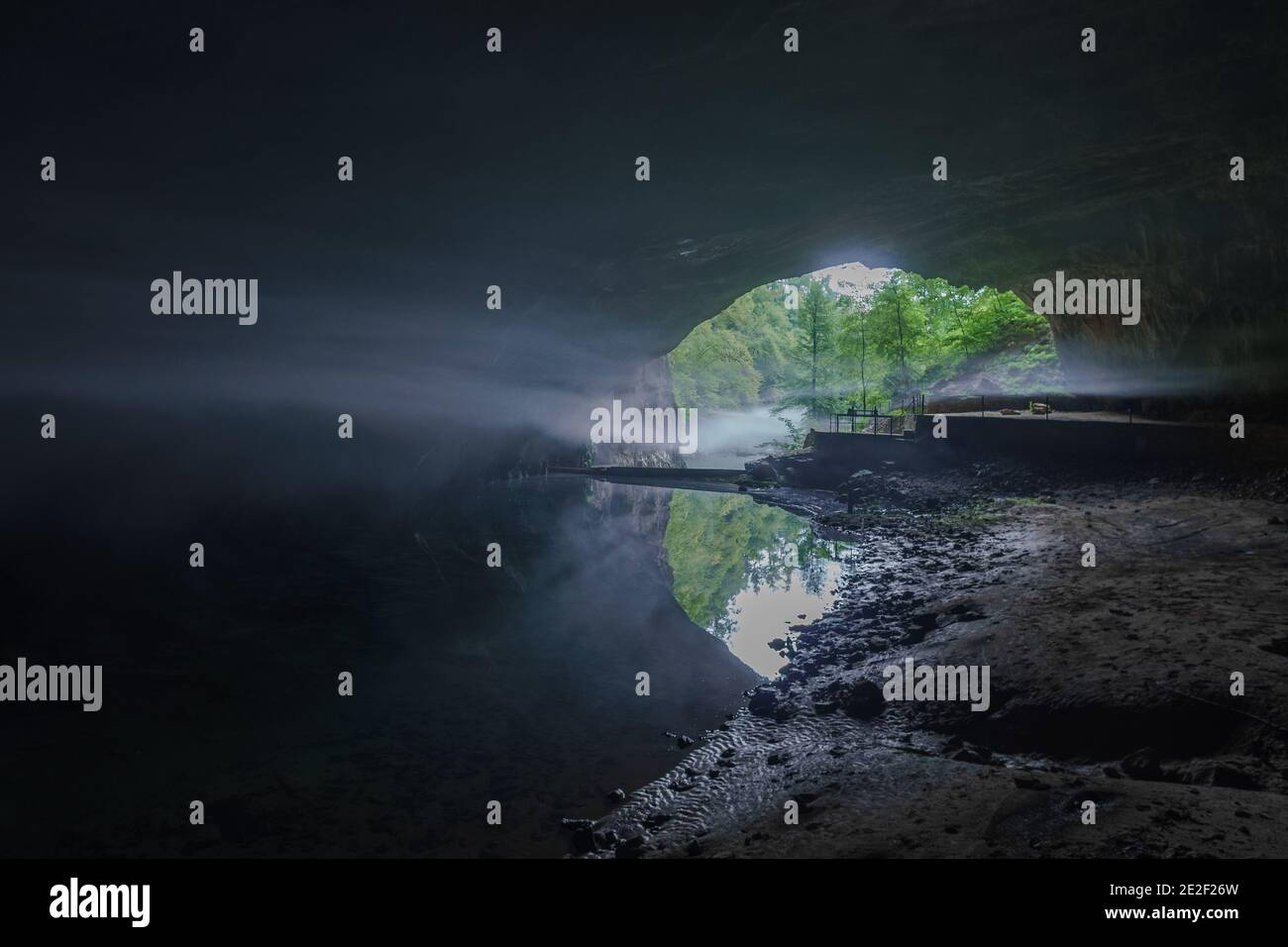 exit of an dark cave with underground river and some fog Stock Photo ...