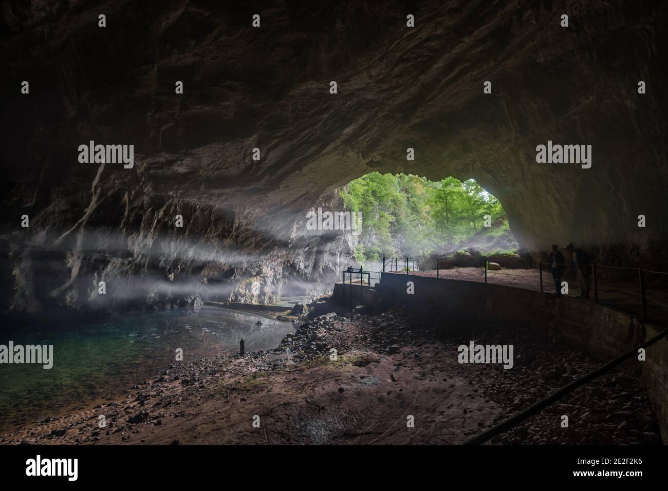 exit of an dark cave with underground river and some fog Stock Photo ...