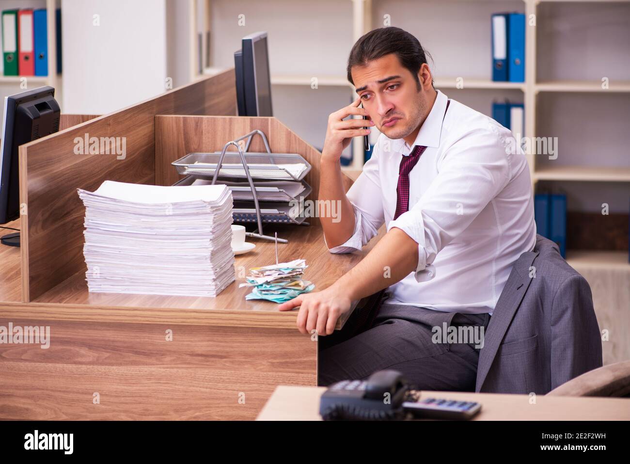 Young employee extremely tired with excessive work Stock Photo - Alamy