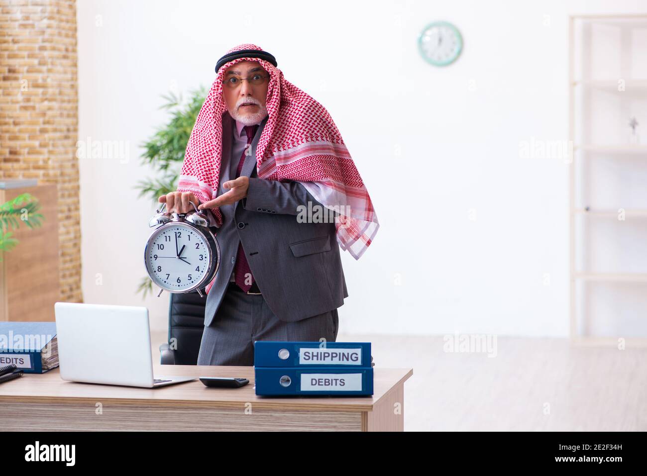 Old arab bookkeeper in time management concept Stock Photo - Alamy