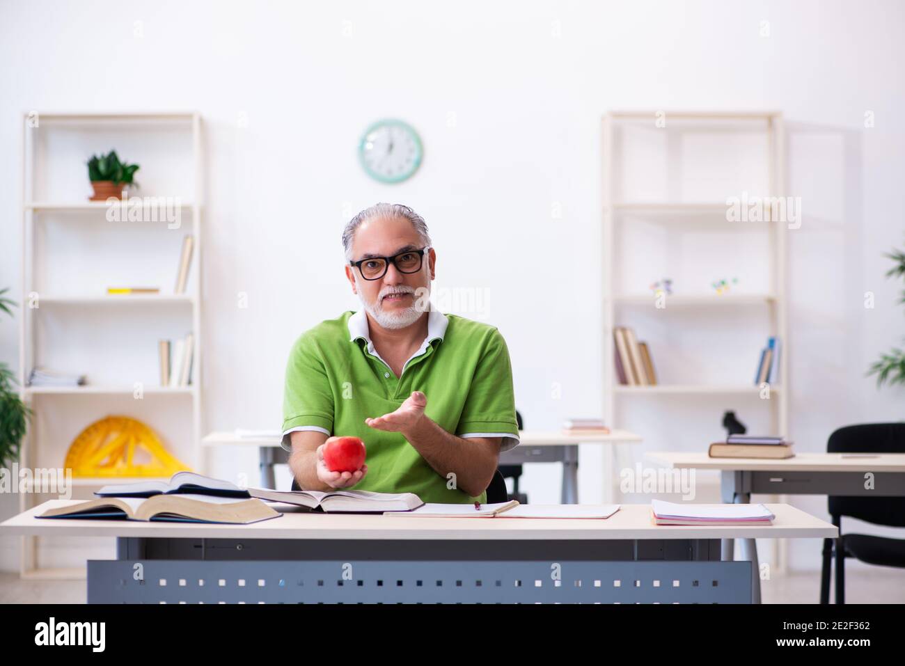 Male teacher eating apple hi-res stock photography and images - Alamy