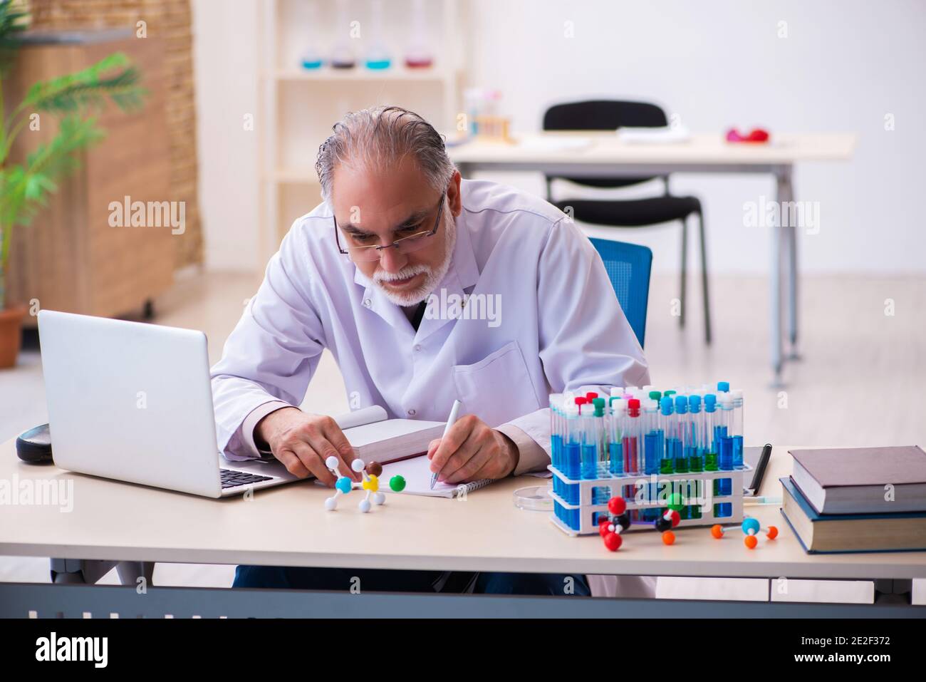 Chemist examining test tubes taking hi-res stock photography and images ...