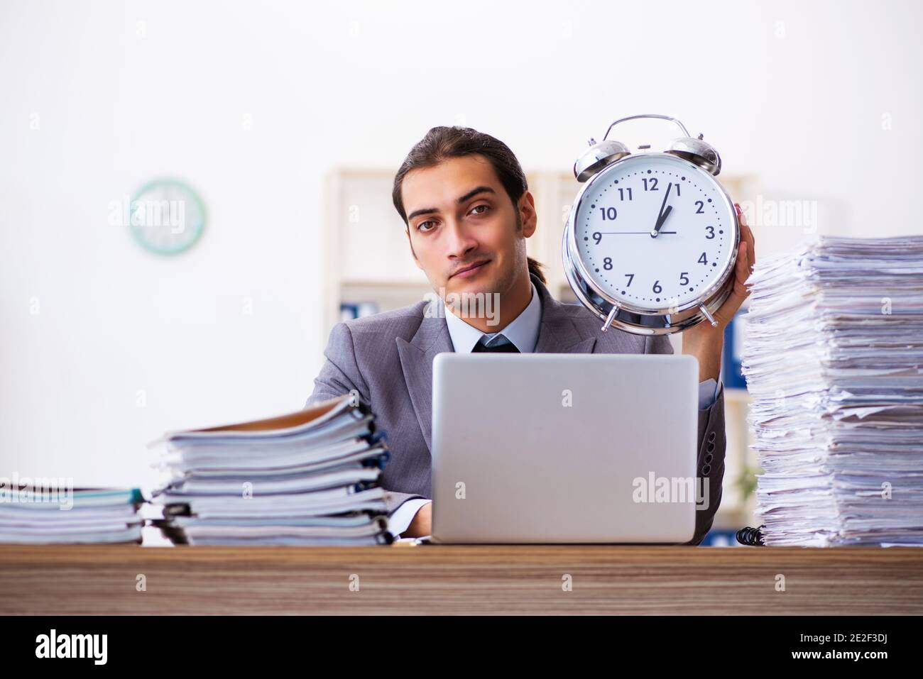 Workload employee in time management concept Stock Photo - Alamy
