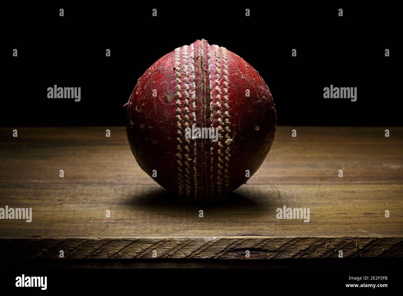 Leather Cricket ball close-up on a wooden surface fine art with copy ...