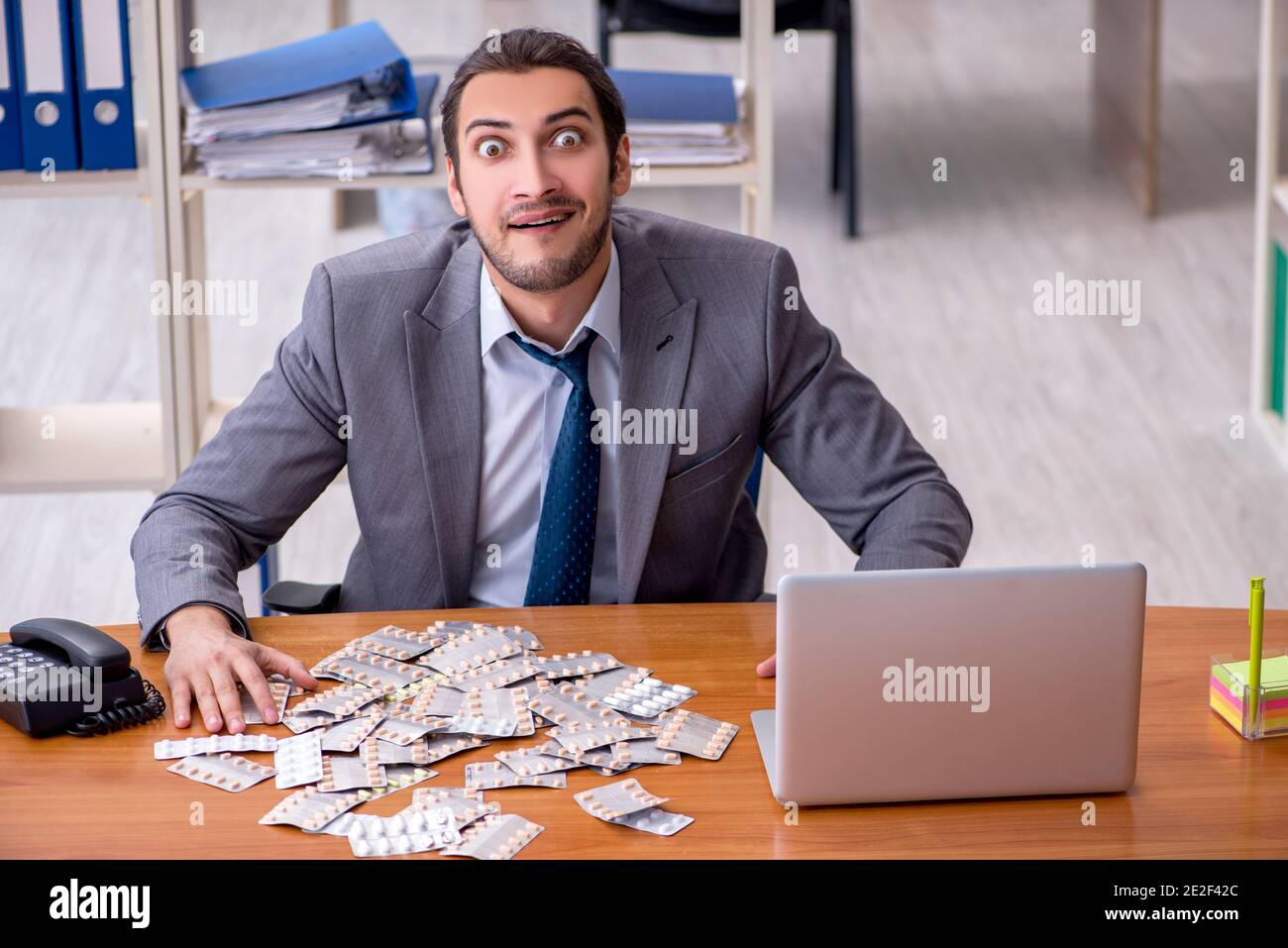 Male sick employee suffering at workplace Stock Photo - Alamy