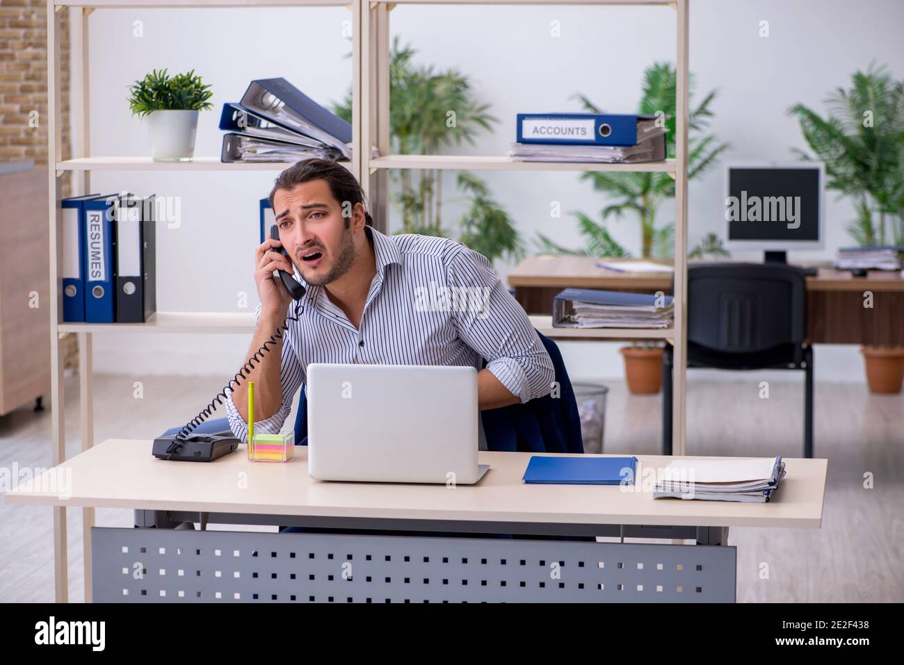 Hungry employee ordering food at workplace Stock Photo - Alamy