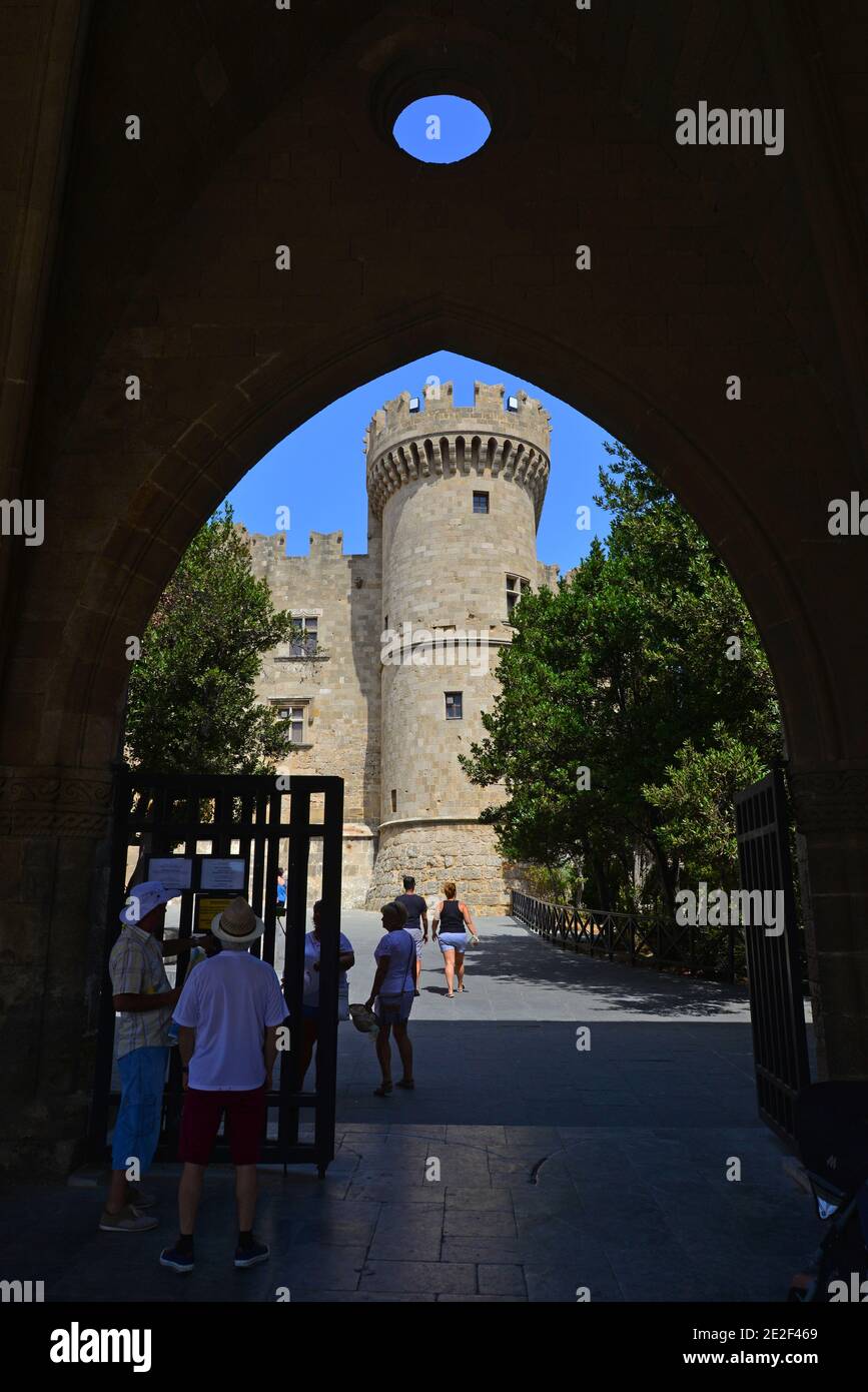 Vertical shot of a historical castle visible through a tunnel in an old ...