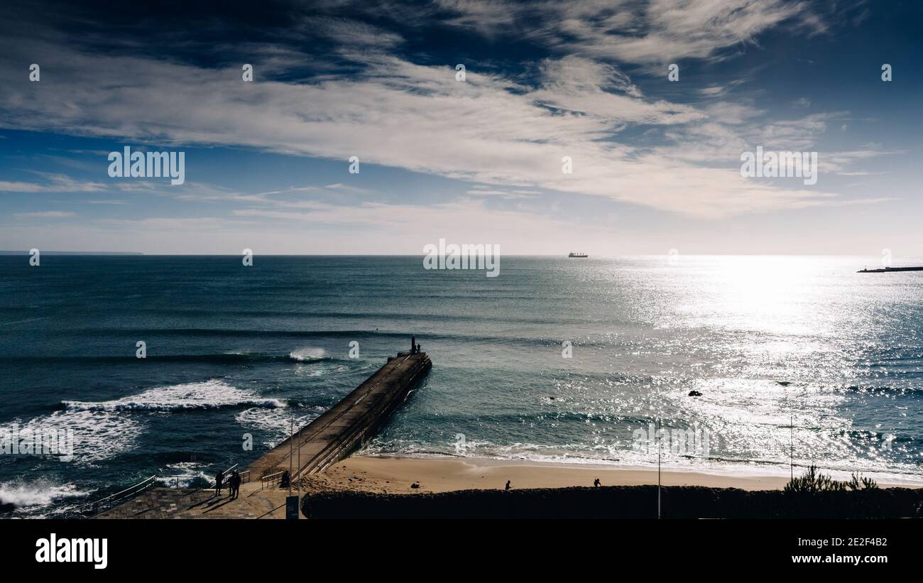 Shot of the beach, stone pier and Atlantic ocean in Cascais, Portugal ...