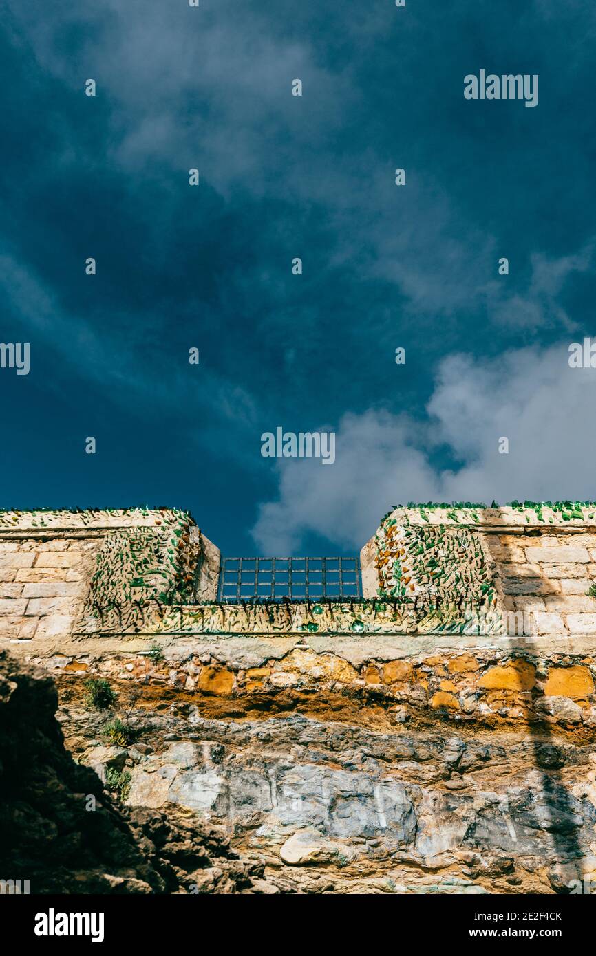 Vertical and low angle shot of an old beautiful balcony in Cascais ...