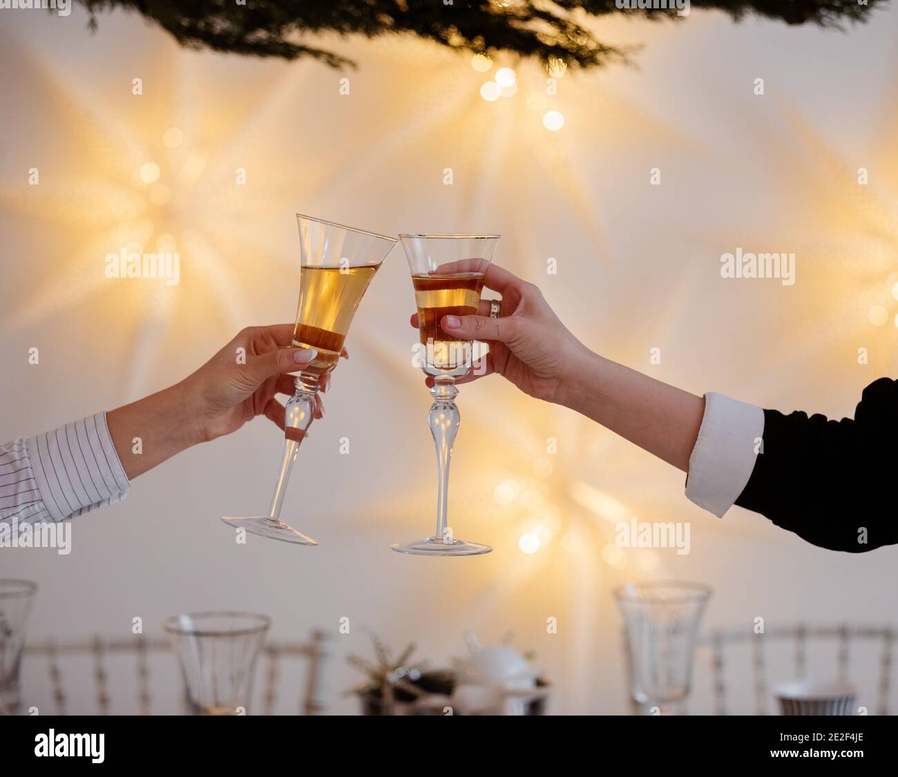 Soft focus of the hands of a couple doing a toast to celebrate their ...