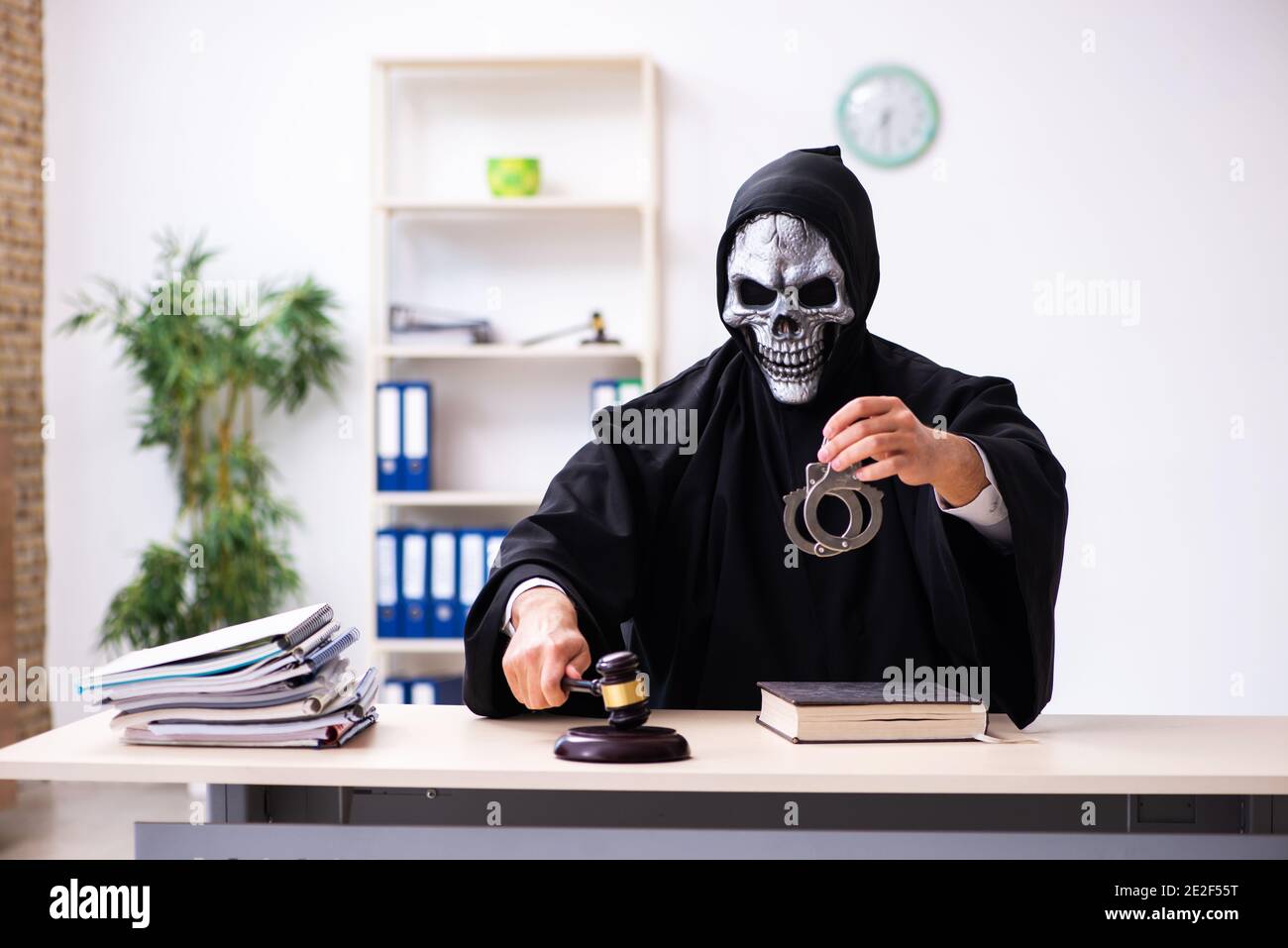 Devil judge working in the courthouse Stock Photo - Alamy