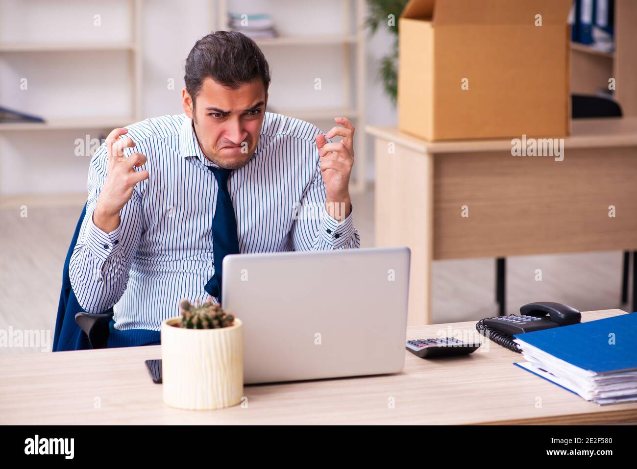 Male employee unhappy with excessive work Stock Photo - Alamy