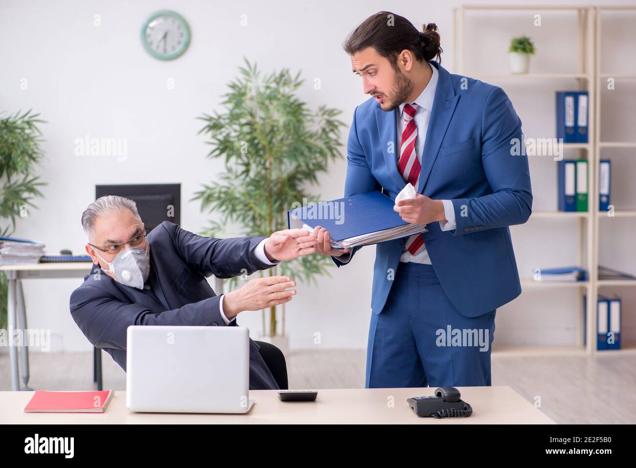 Employees at workplace during pandemic Stock Photo - Alamy