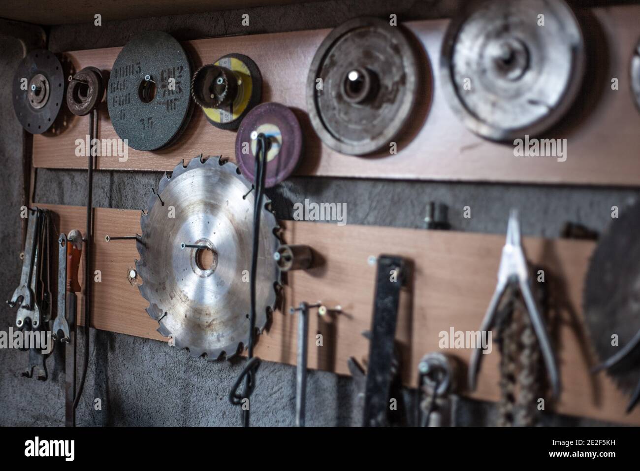 Metal instruments and tools hanging from a wall in a repair shop Stock ...