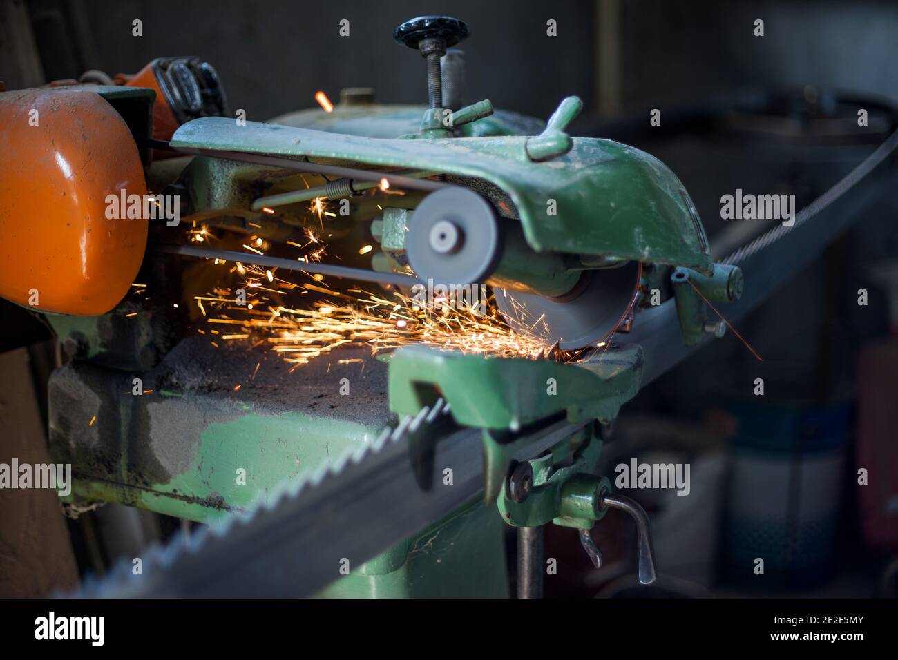 Industrial powerful machine cutting metal surface with sparks coming ...