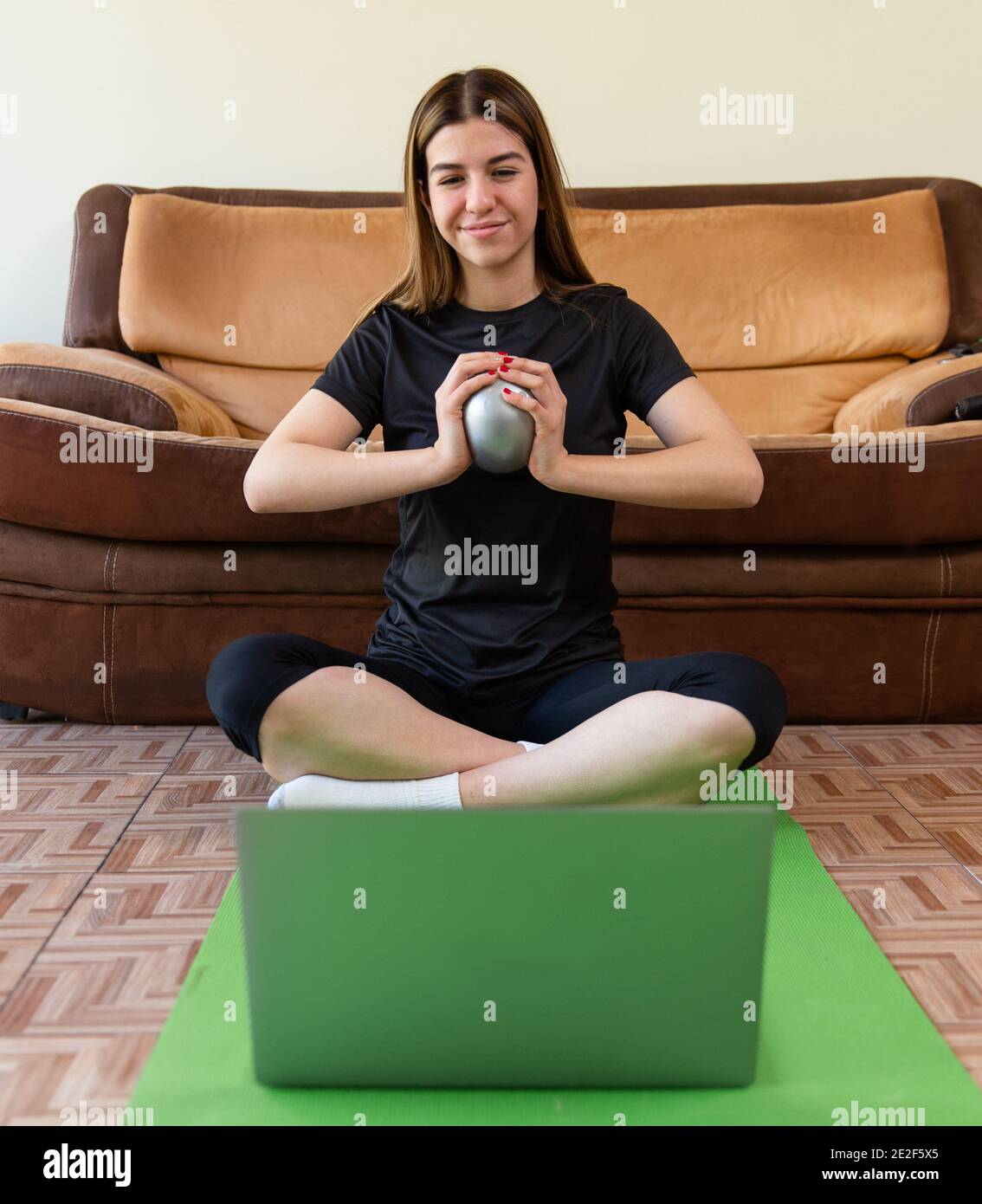 Determined female athlete in sportswear watching video tutorial on ...
