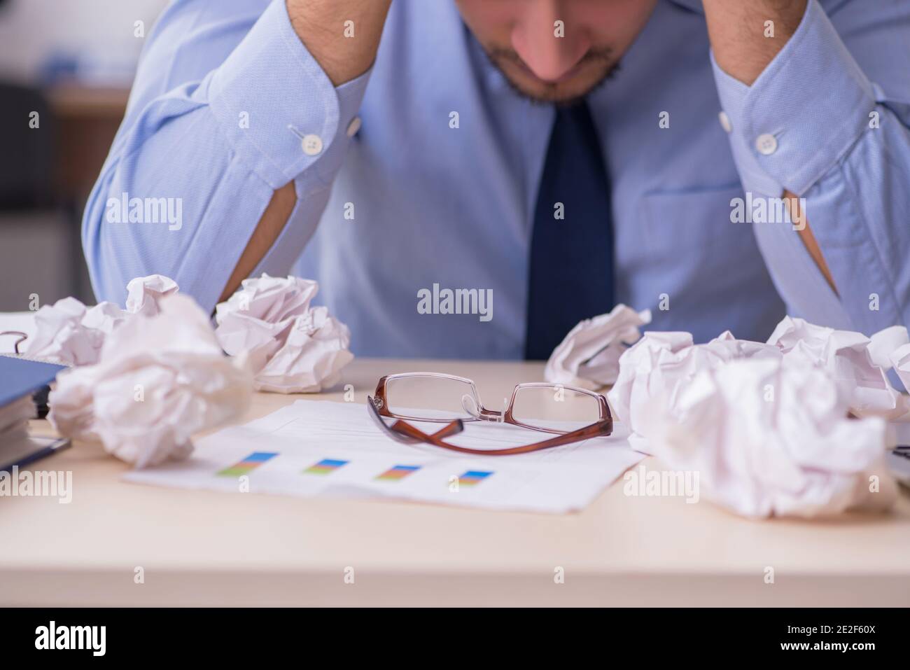 Sick male employee suffering at the workplace Stock Photo - Alamy