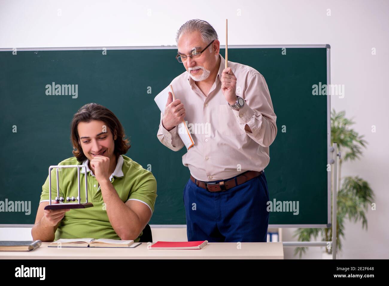 Old professor physicist and student in the classroom Stock Photo - Alamy