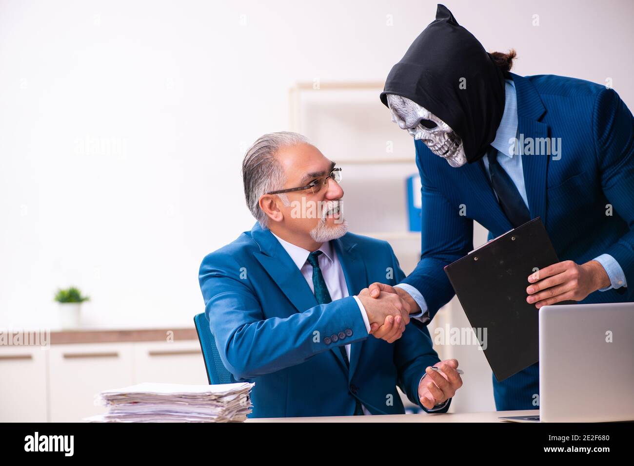 Old businessman employee making deal with the devil Stock Photo - Alamy