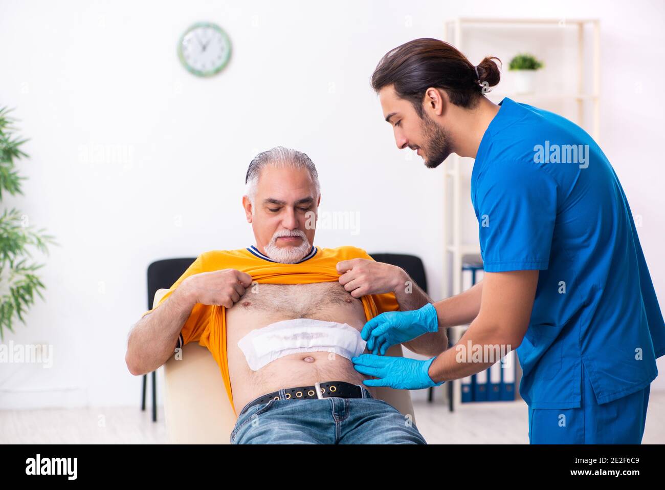Old man visiting male doctor Stock Photo - Alamy