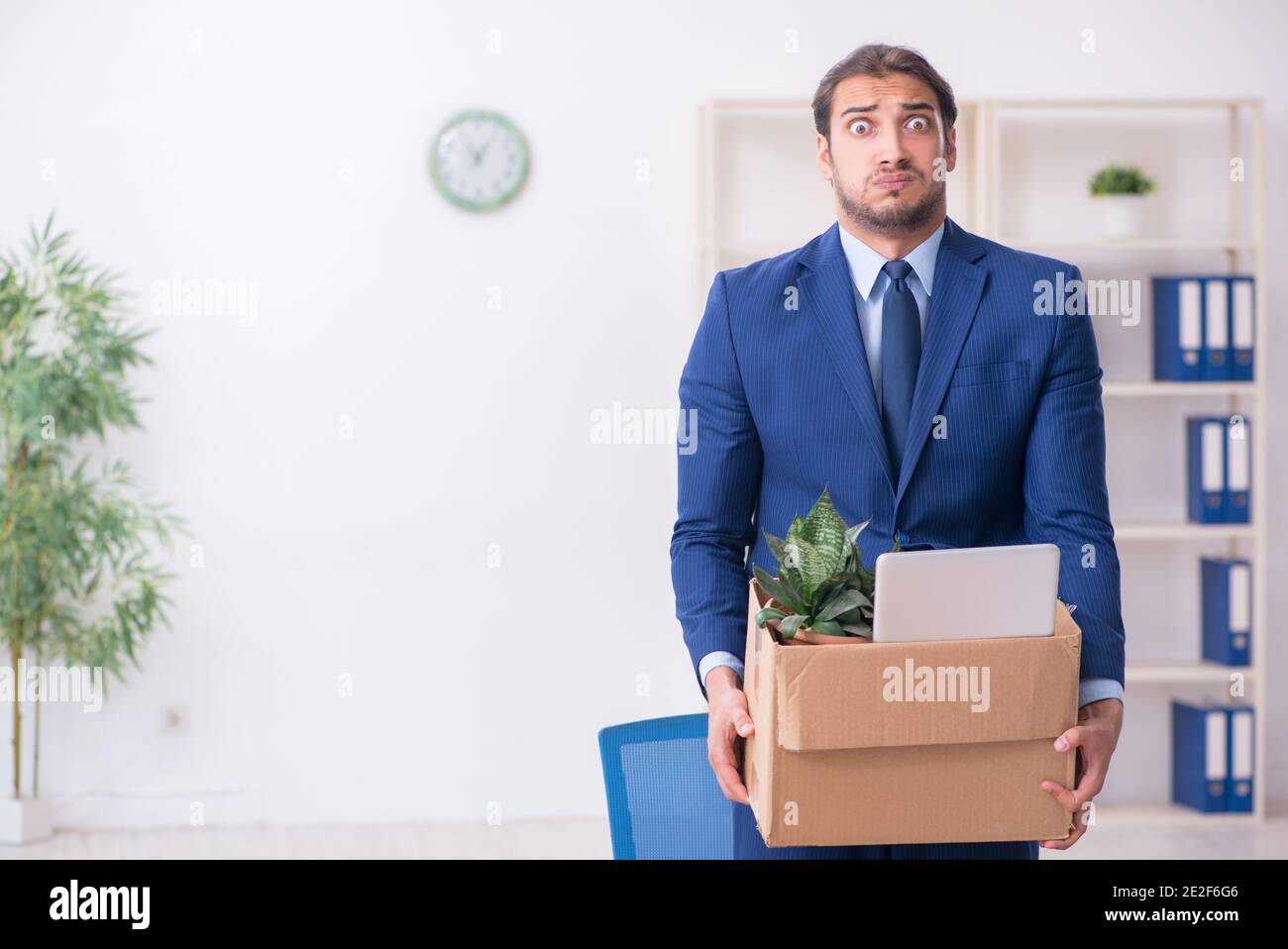 Young man being fired from his workplace Stock Photo - Alamy