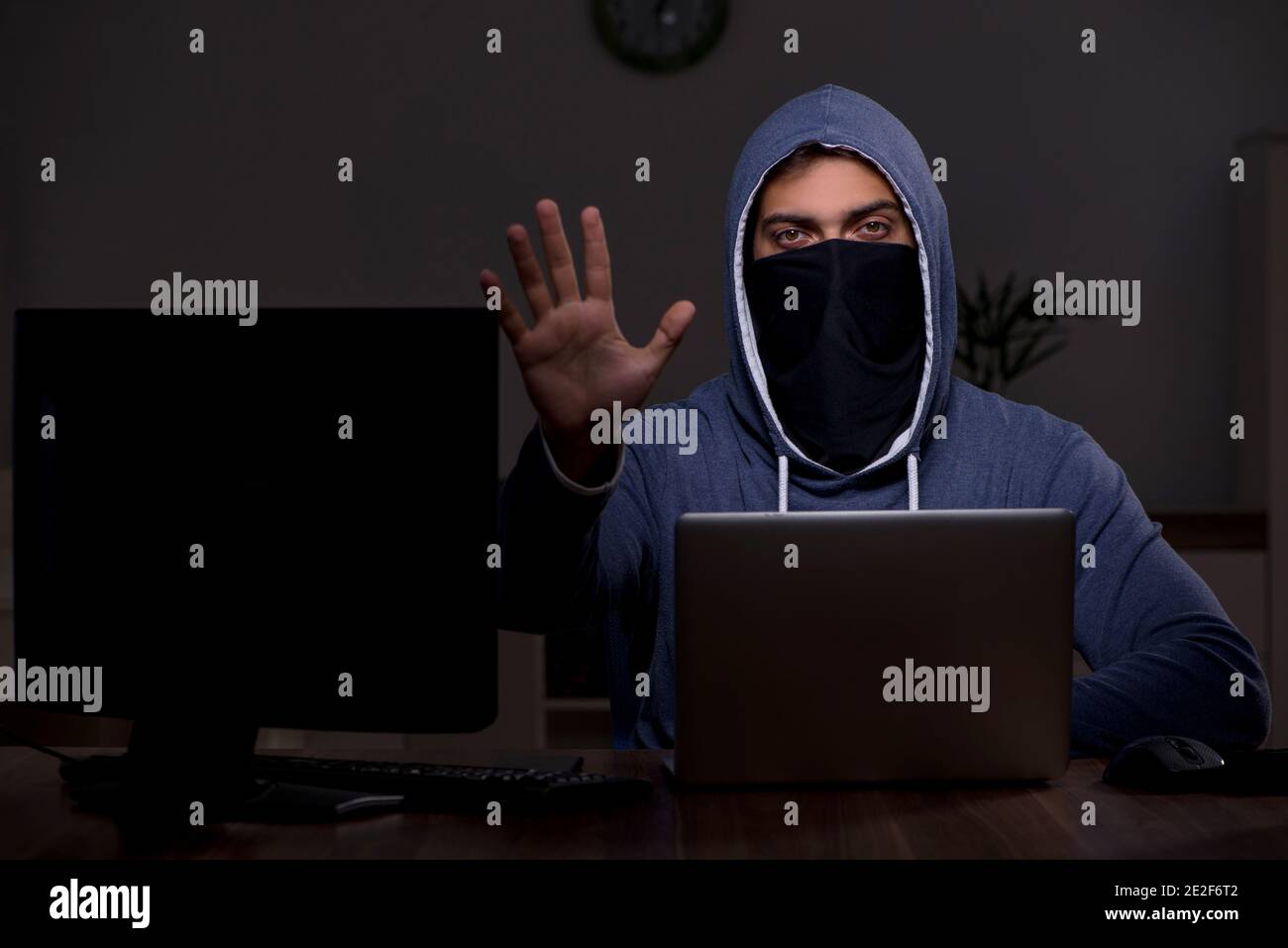 Male hacker hacking security firewall late in the office Stock Photo ...