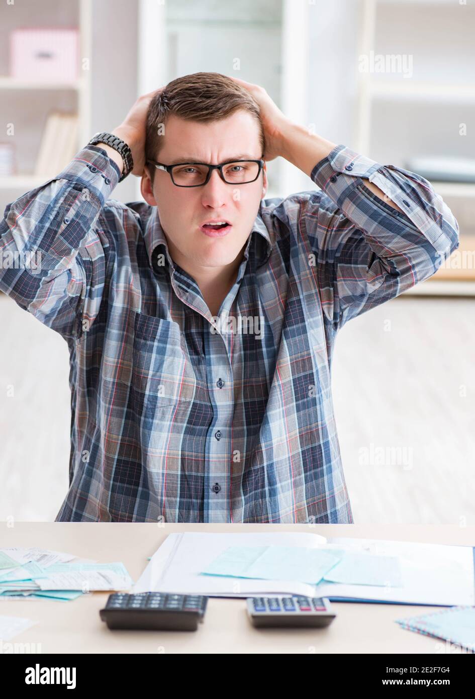 The young man frustrated at his house and tax bills Stock Photo - Alamy