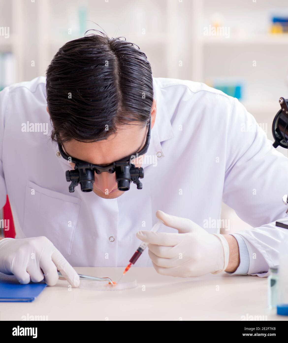 The drug synthesis concept with chemist working in research lab Stock ...