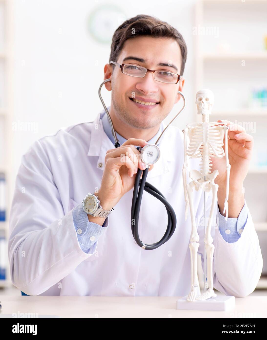 The doctor explaining human body on skeleton Stock Photo - Alamy