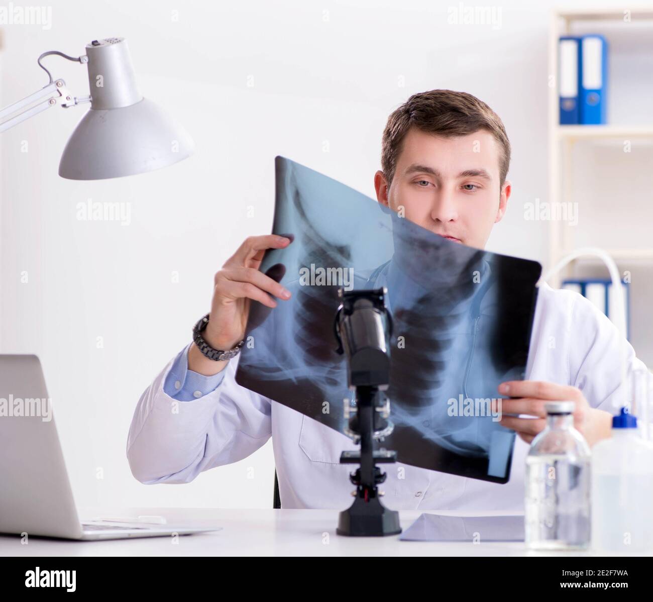 The male doctor looking at lab results in hospital Stock Photo - Alamy