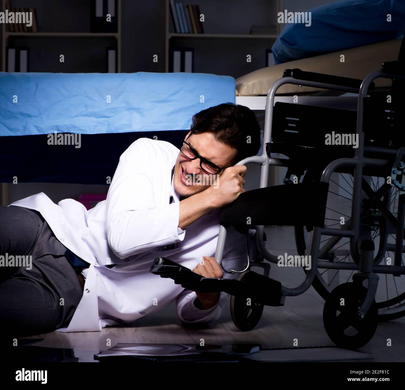 The doctor working night shift in hospital after long hours Stock Photo ...