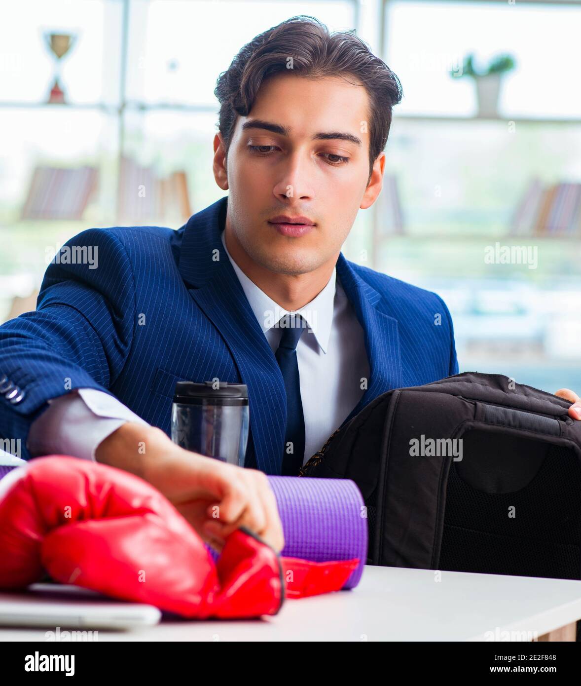 The man with boxing gloves in the office Stock Photo - Alamy