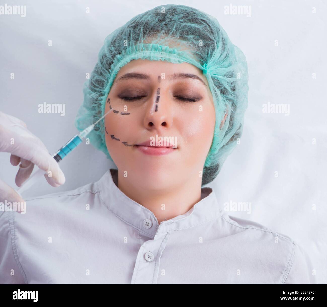 The plastic surgeon preparing for operation on woman face Stock Photo ...