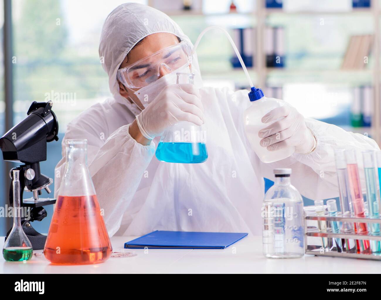 The chemist working in the laboratory with hazardous chemicals Stock ...