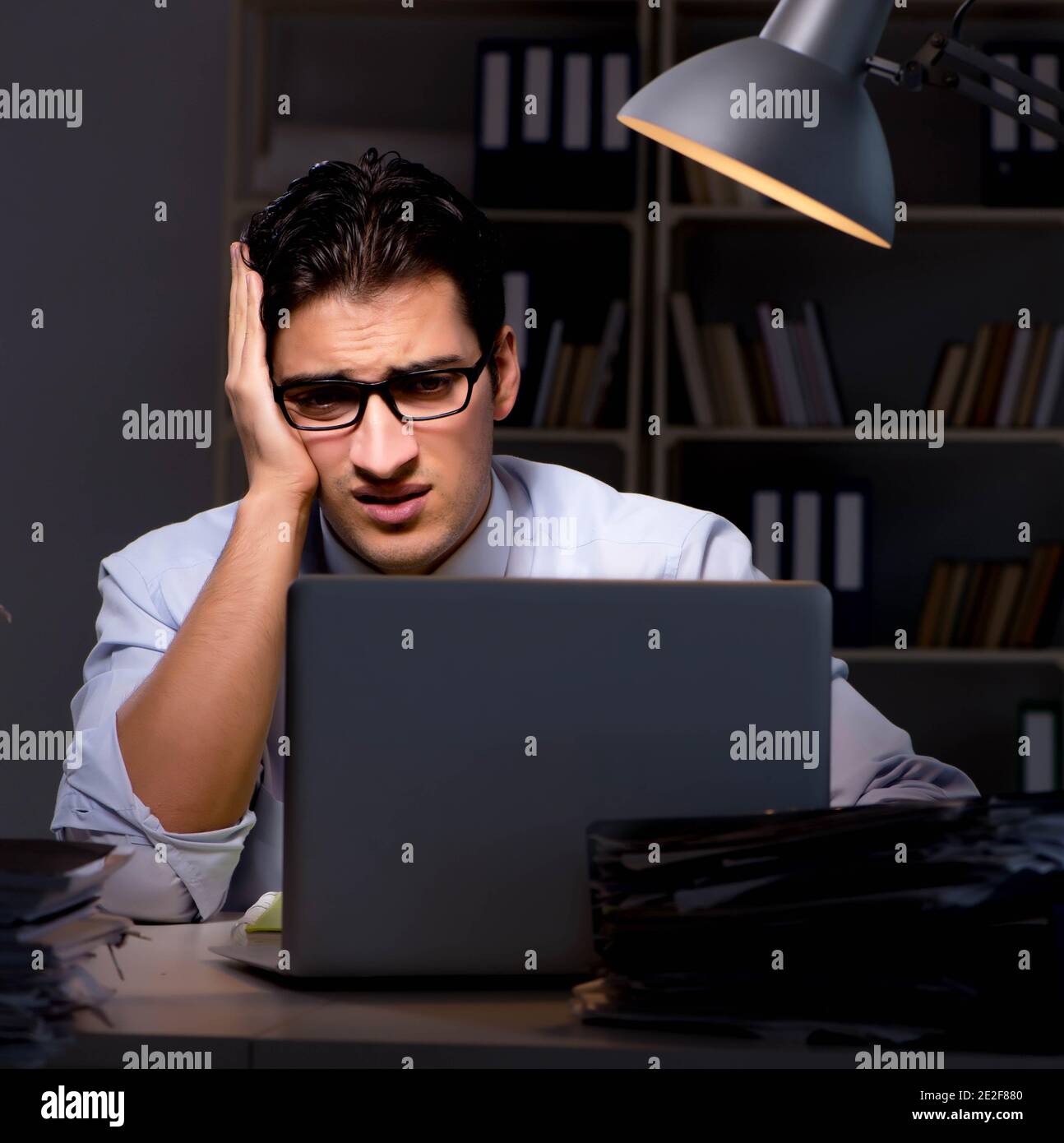The young businessman working overtime late in office Stock Photo - Alamy