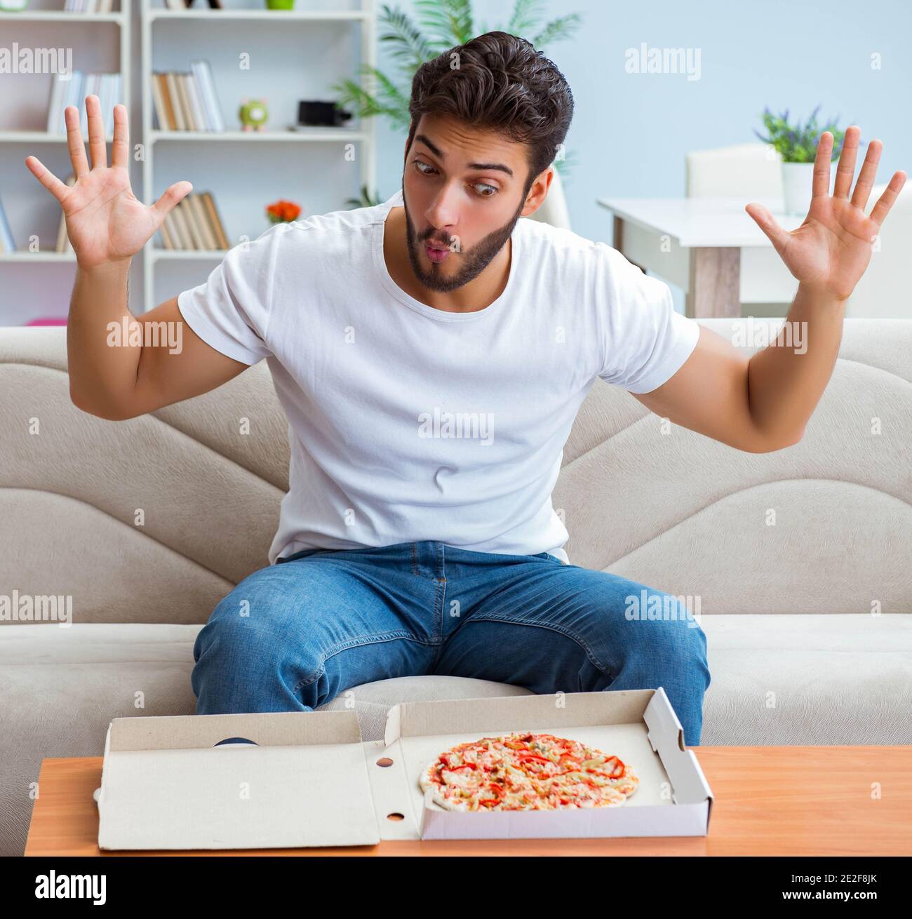 The man eating pizza having a takeaway at home relaxing resting Stock ...